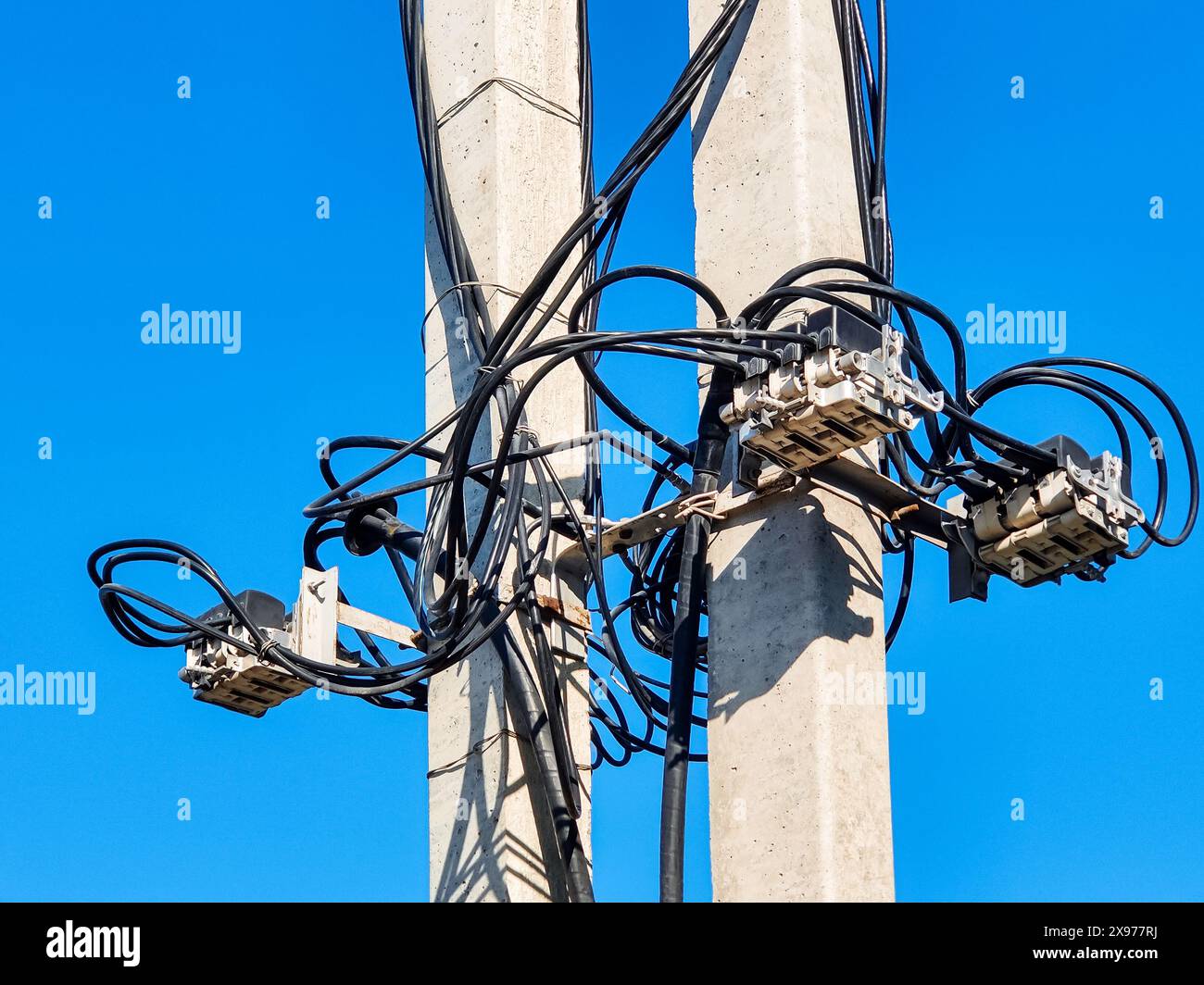 Concrete pillars with electrical wires, coils of cables and switching ...