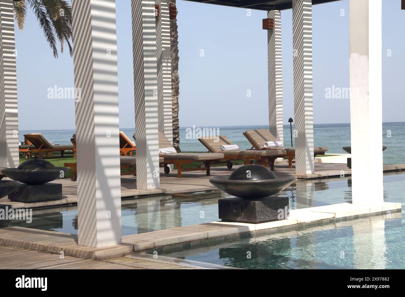 Sun Loungers under Shelter by Infinity Pool at The Chedi Hotel Muscat ...