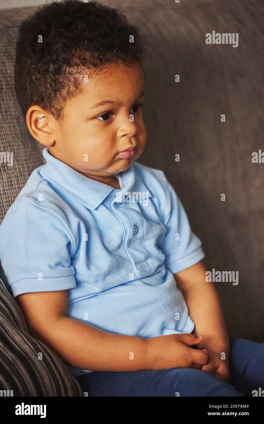 Tilst, Denmark, 12th of August: Cute boy watching TV on the sofa Stock ...