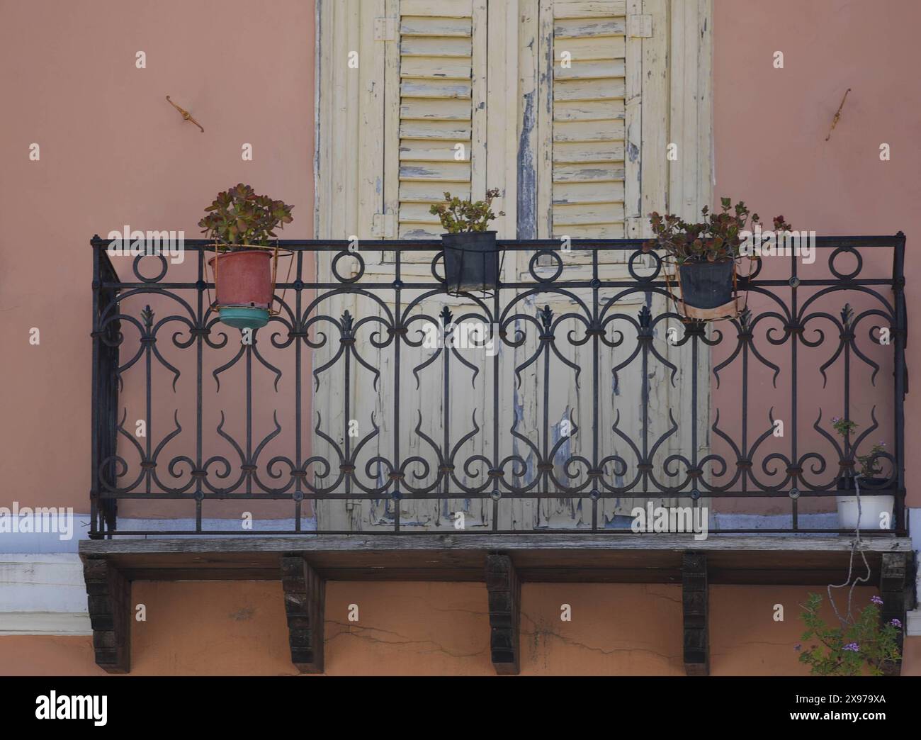 Neoclassical house facade with wooden window shutters and a balcony ...