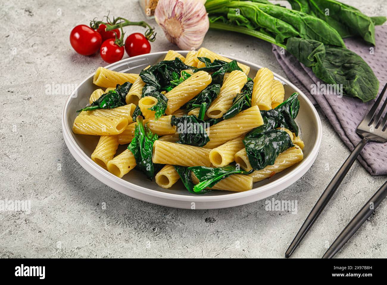 Italian cuisine - pasta tortiglioni with spinach Stock Photo - Alamy