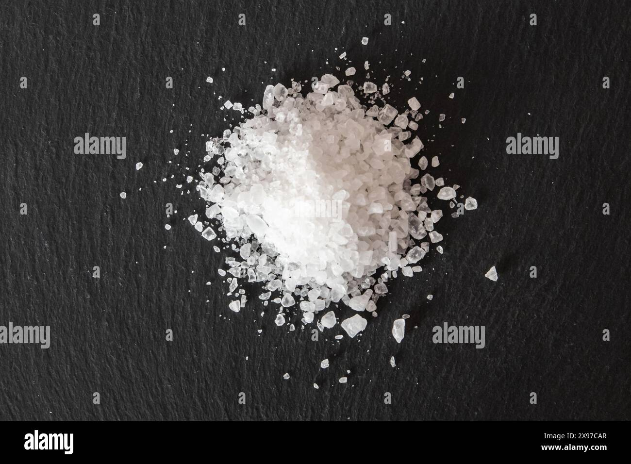 White salt cristals on the black background. Salt crystals for cooking ...