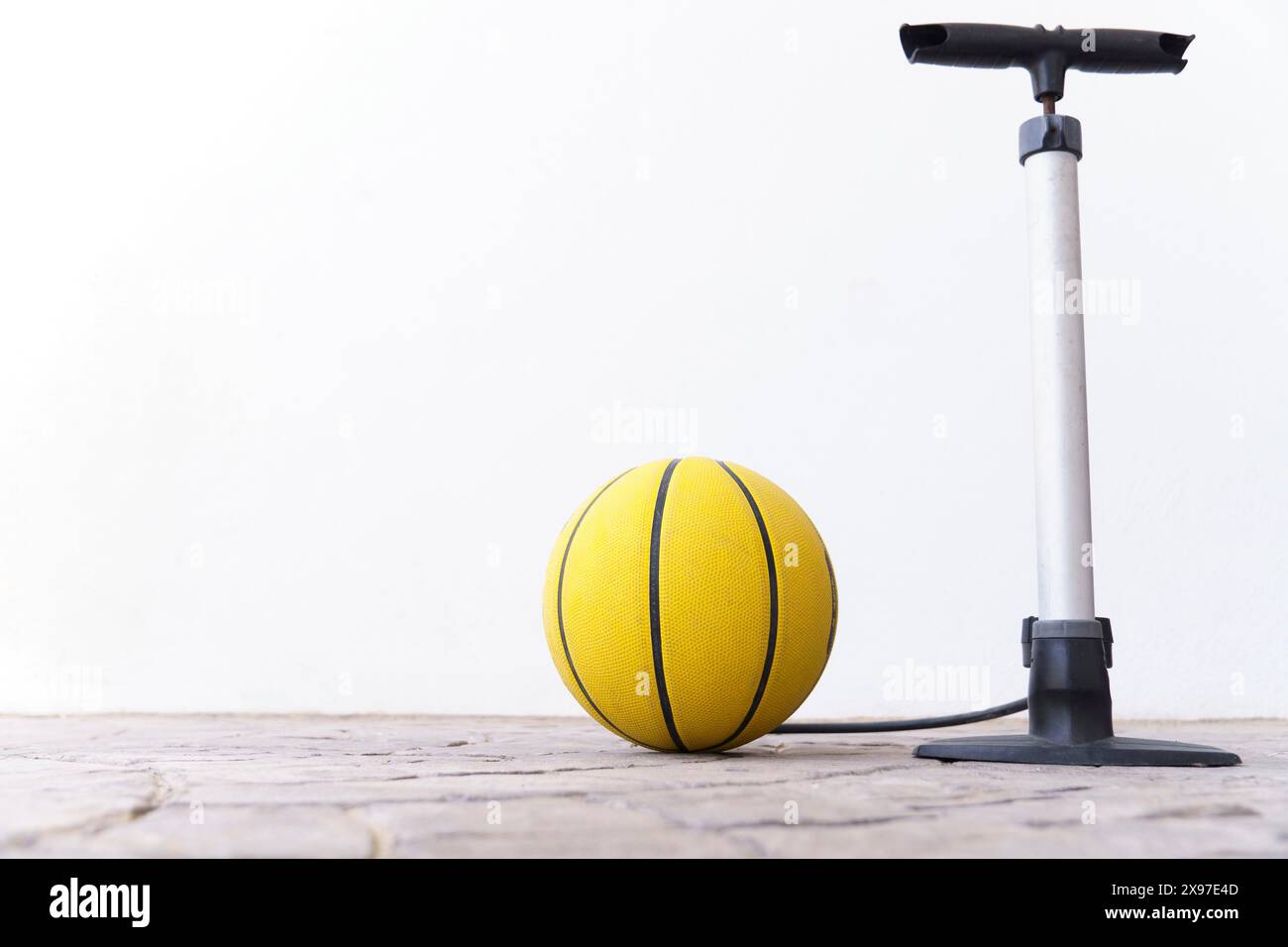 Basketball inflated with a hand pump on a white background Stock Photo ...