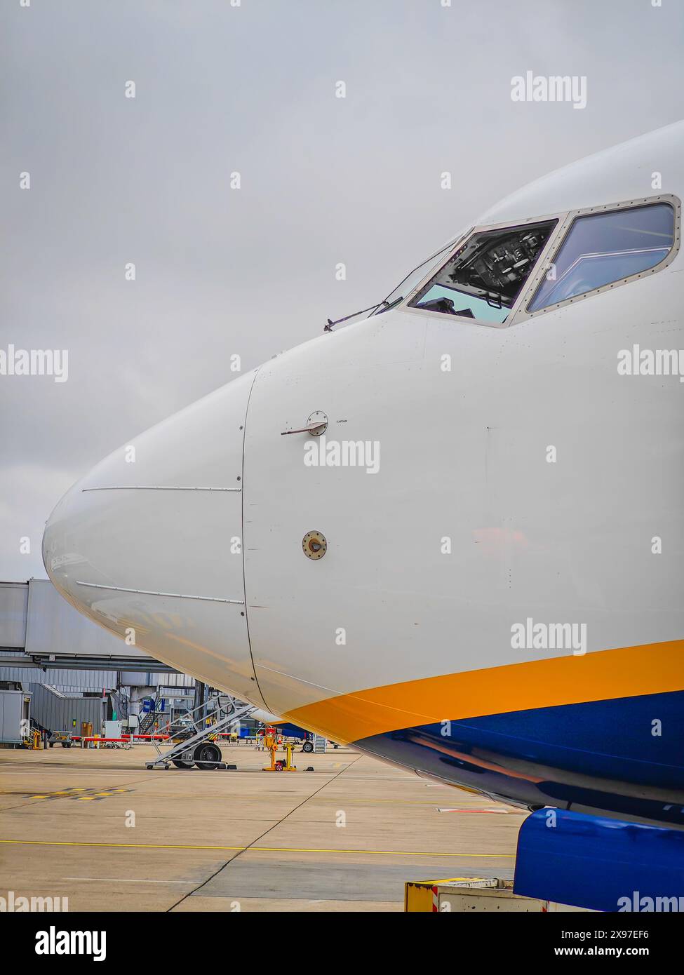 Side view of front of passenger aircraft and cockpit standing in a ...