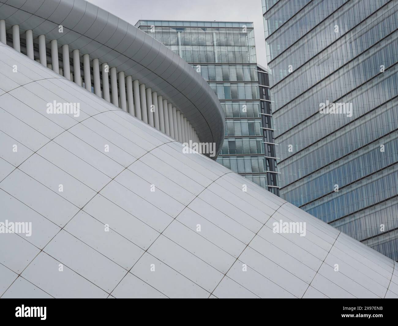 Architecturally modern building with white structure and neighbouring ...