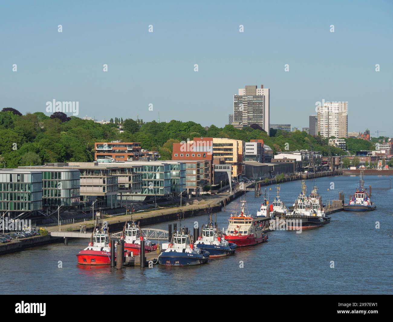 River section with modern buildings and numerous boats under a clear ...