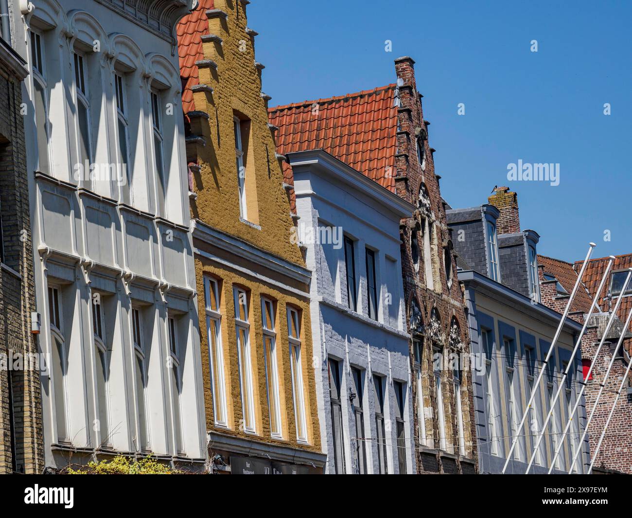 Row of historic buildings with ornate gables under a clear blue sky ...