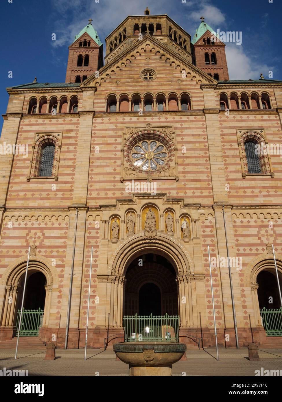 Frontal view of a gothic sandstone cathedral facade with towers under a ...