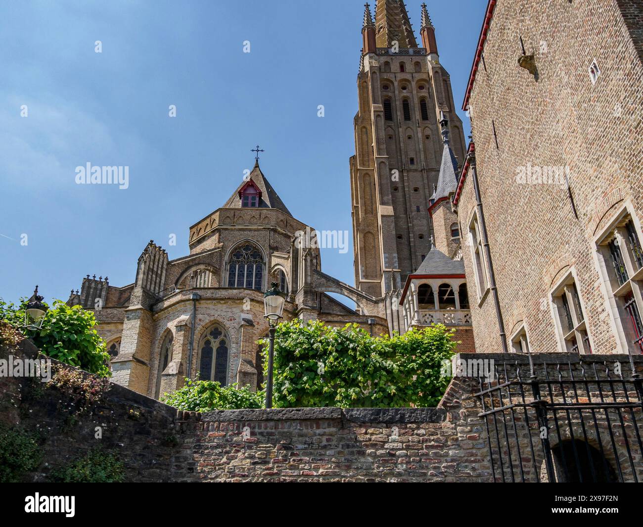 Gothic cathedral with high towers and brick walls on a summer day ...