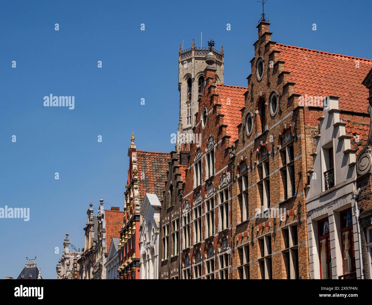 Detail of buildings with decorated towers and roof tiles under a clear ...