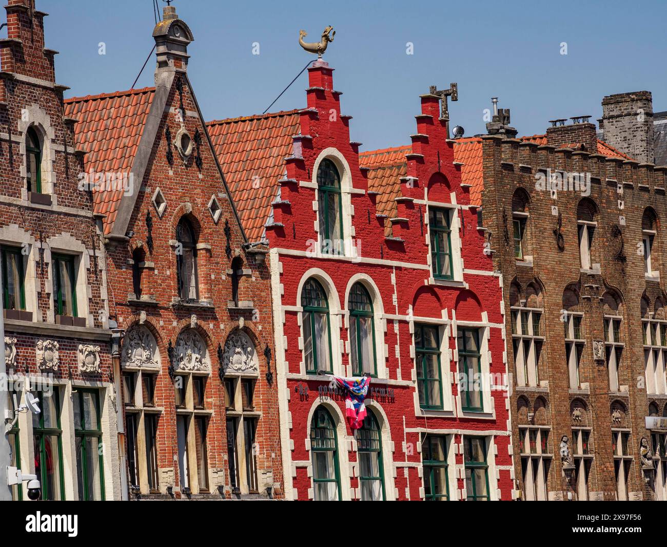 Row of colourful historic houses with gabled roofs and large windows ...