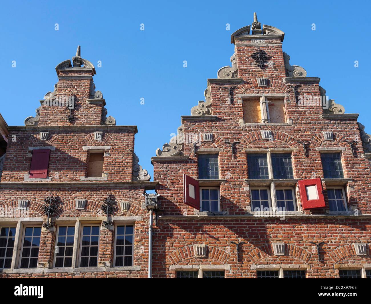 Historic red brick buildings with ornate facades and turrets under a ...