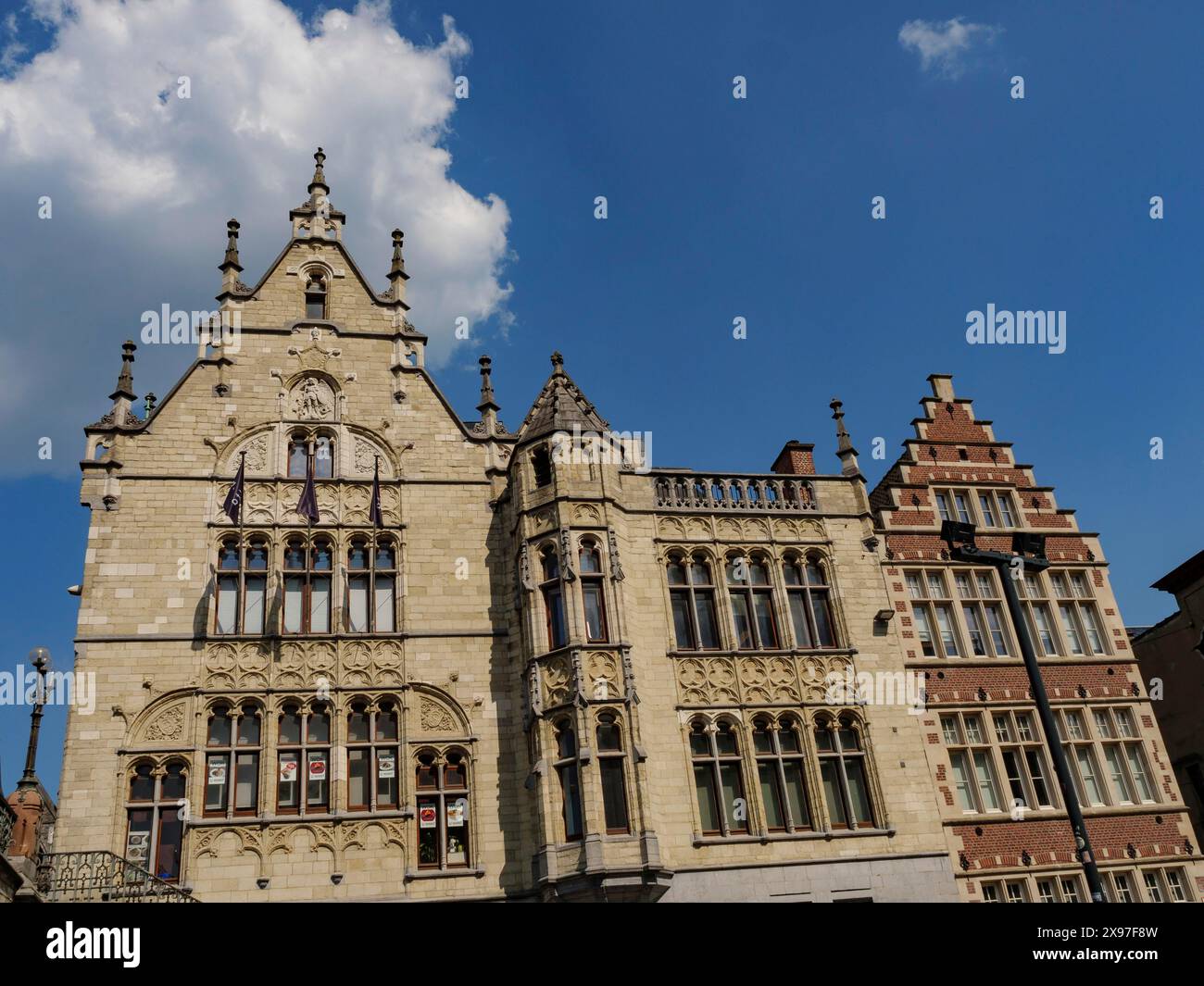 Ornamental historic facades in gothic style against a bright blue sky ...
