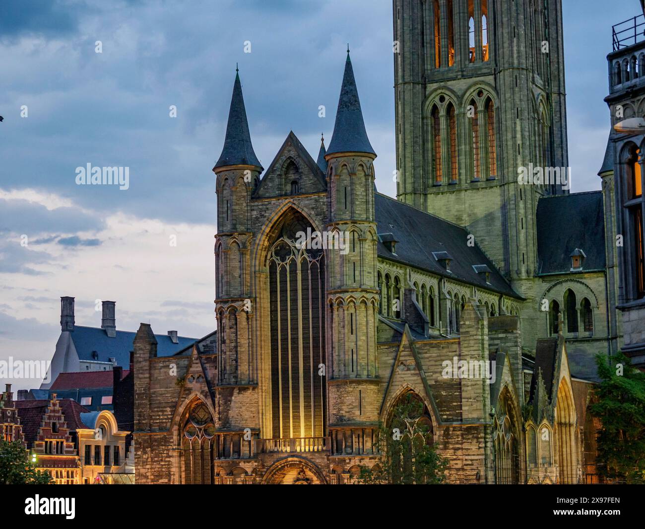Gothic church with high towers and large windows, evening lighting ...