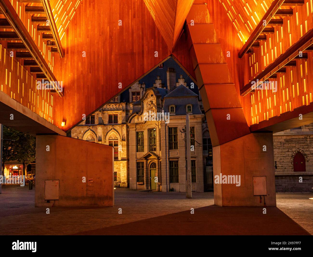 Modern wooden building with architectural lighting in contrast to a ...