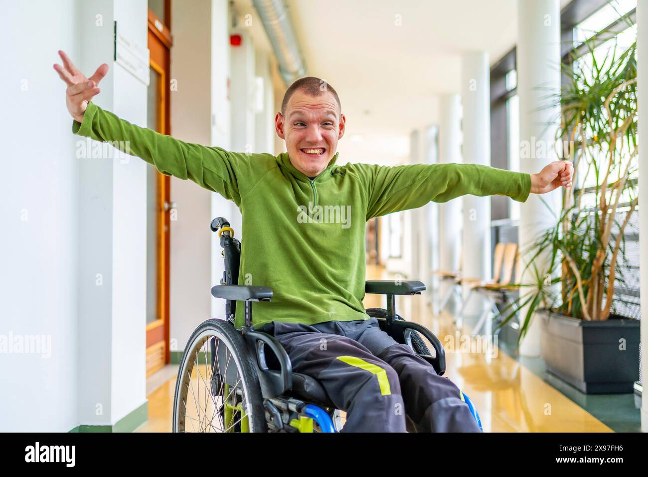Caucasian adult man with cerebral palsy stretching arms celebrating he ...