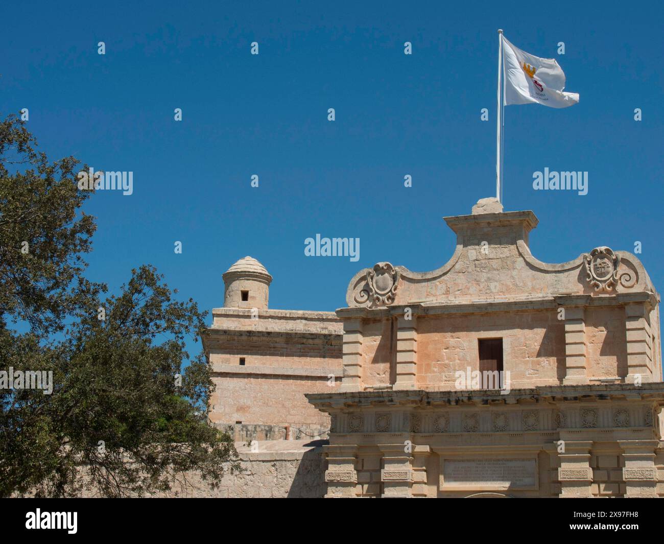 An old castle with a flag and a tower in the foreground, bright blue ...