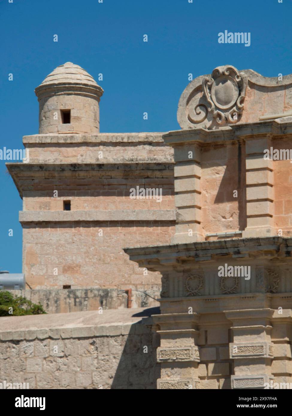 A tower and castle walls of an old castle under a blue sky, Historic ...