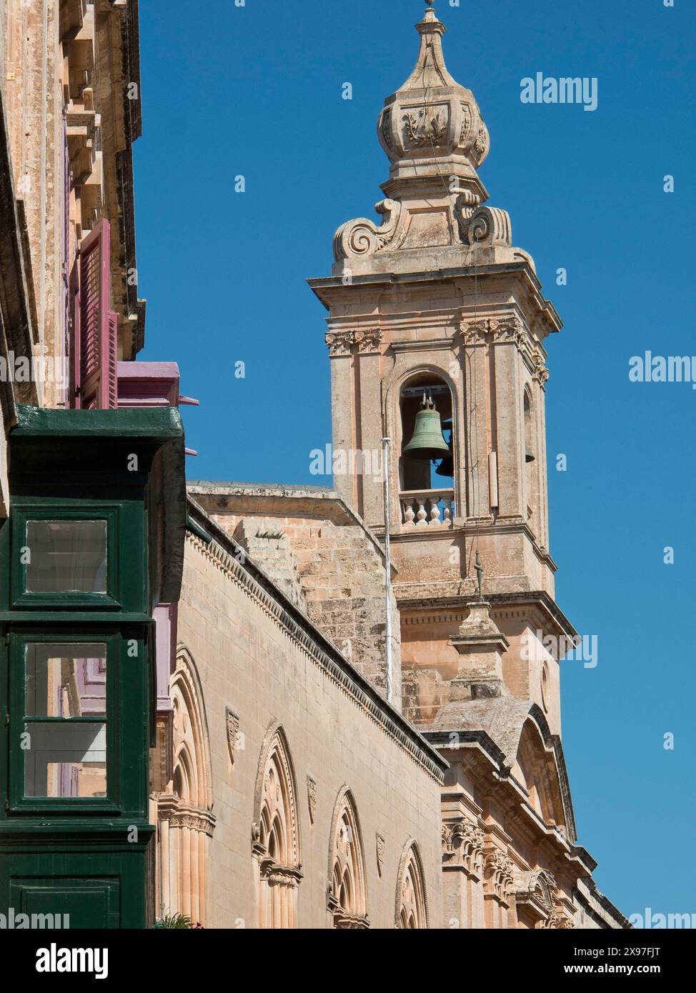 Baroque bell tower of a historic building under a clear blue sky ...