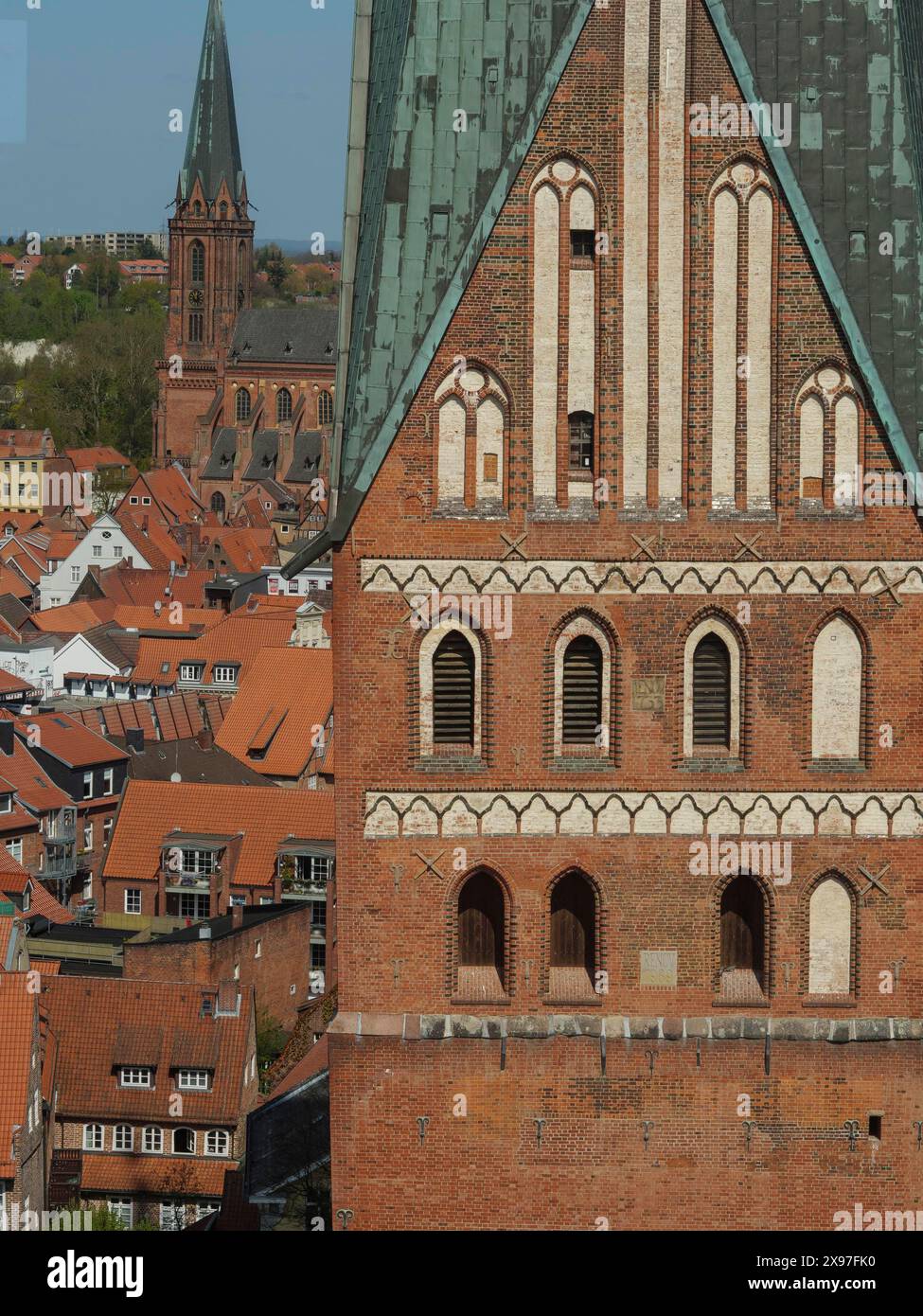 Partial view of a gothic brick church tower and surrounding medieval ...