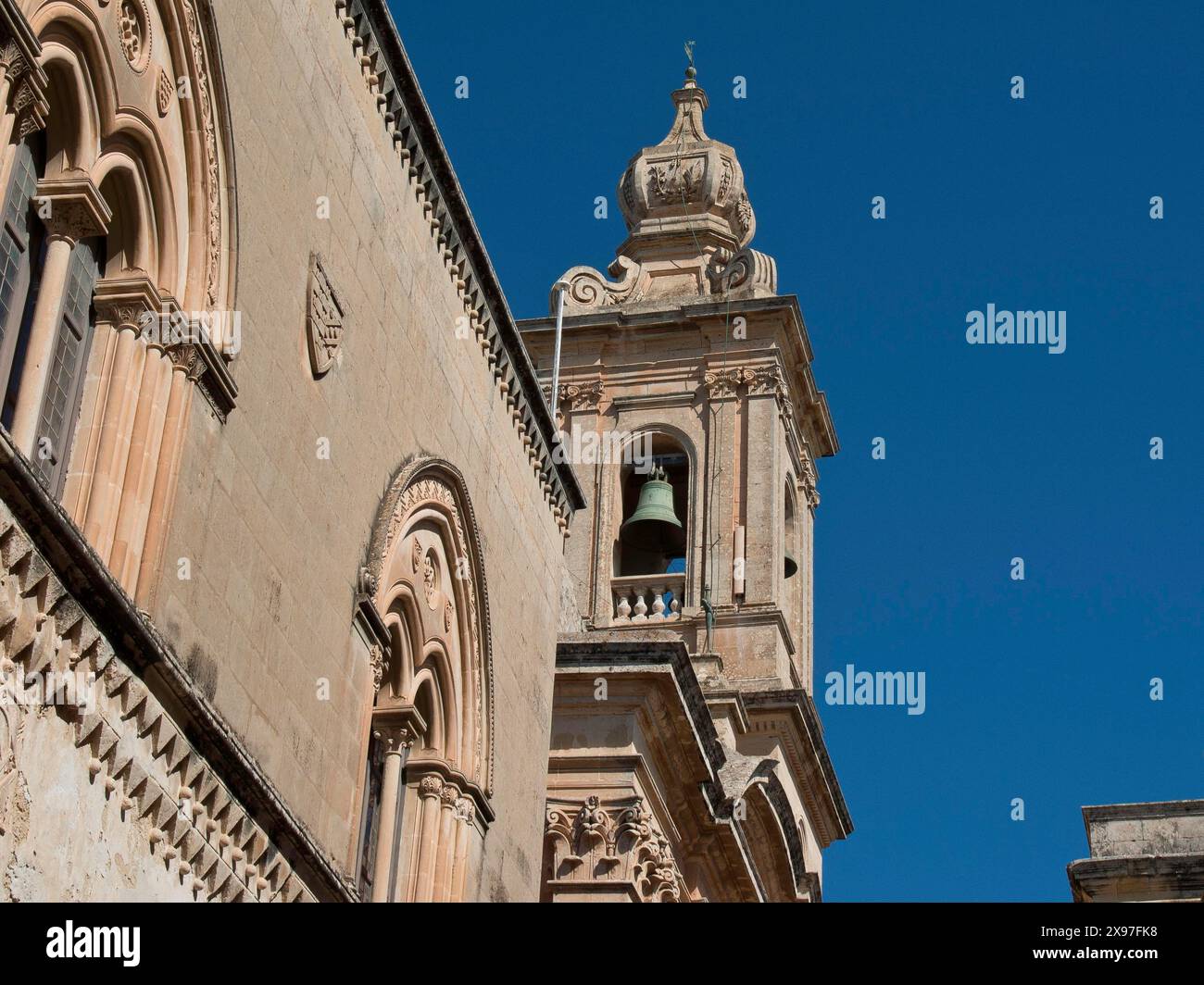 Baroque elements of a historic church tower with bell and decorated ...