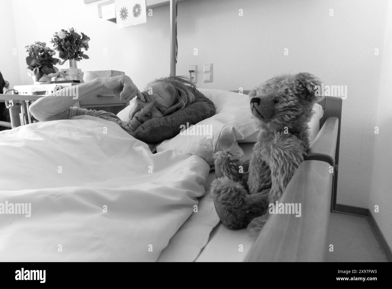Senior citizen with dementia lying in her room in a retirement home ...