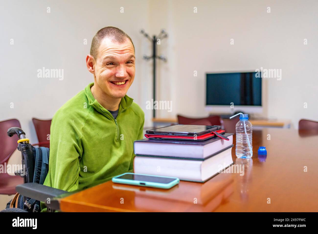 Man with disability sitting in wheelchair in the study room of the ...