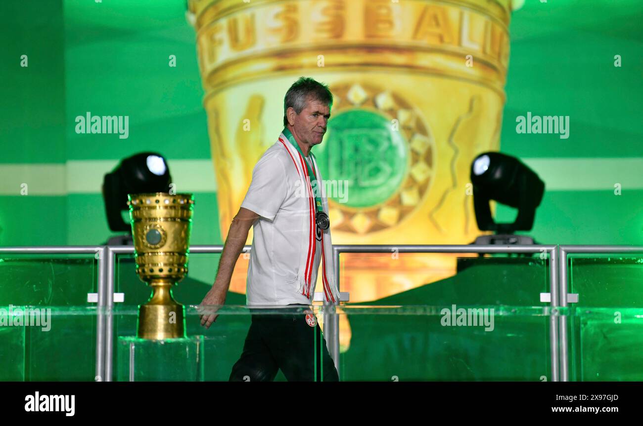 Coach of 1. FC Kaiserslautern Friedhelm Funkel walks past the cup in ...