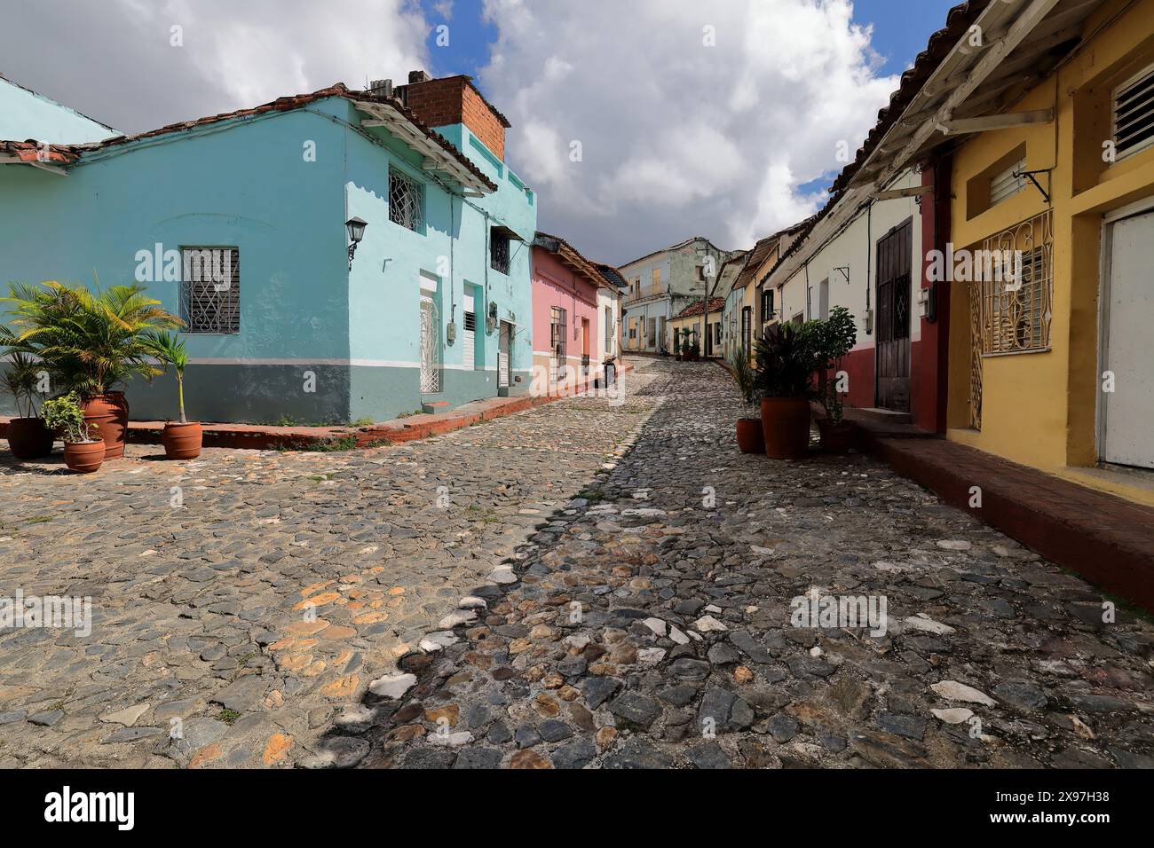 339 Stone-paved Calle Llano Street, curving slope-up from the riverside ...