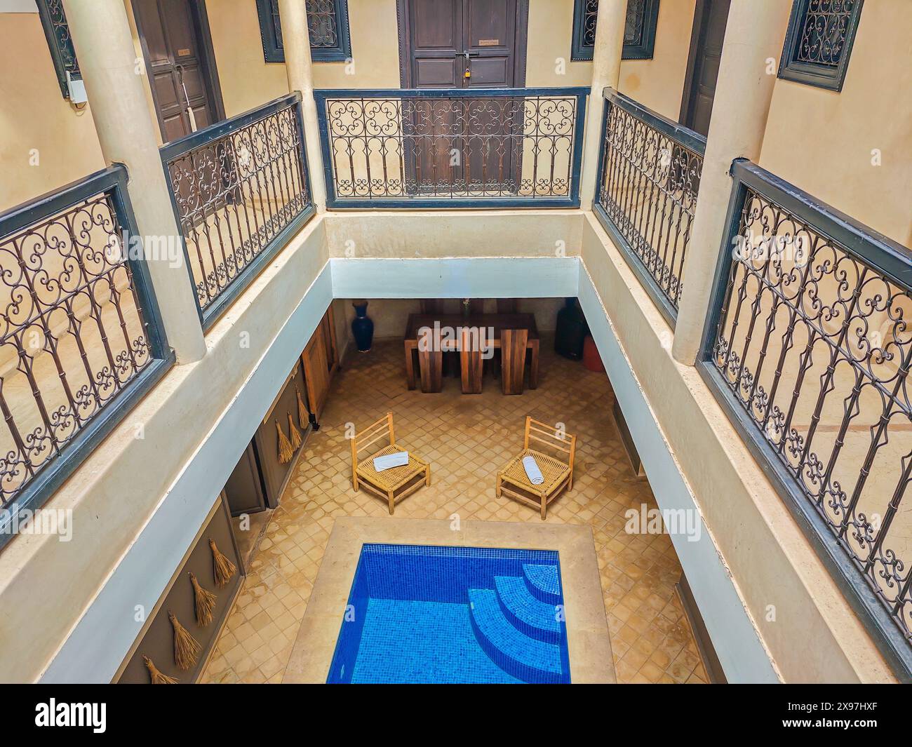 Interior of a typical Moroccan riad with a small pool in the middle of ...