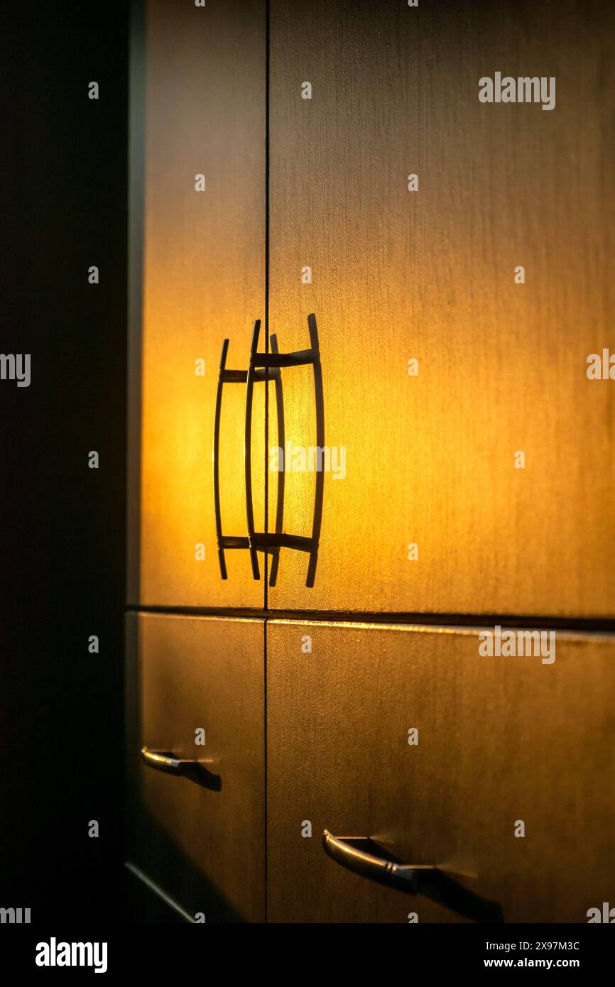 Wooden Drawer Cabinets with metal handles - selective focus. Evening ...