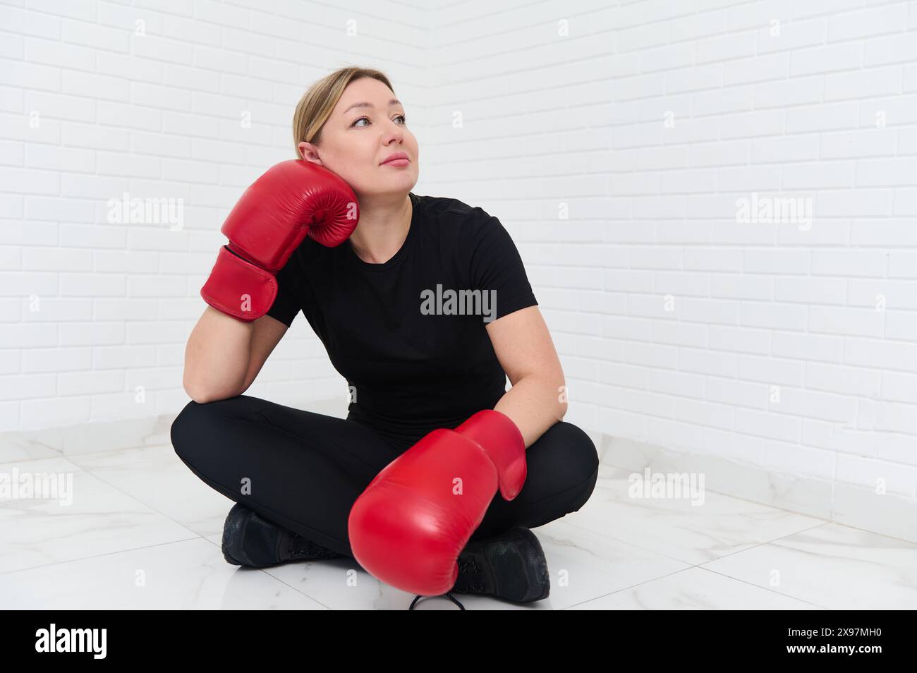 Authentic portrait of a happy European young sports woman boxer ...