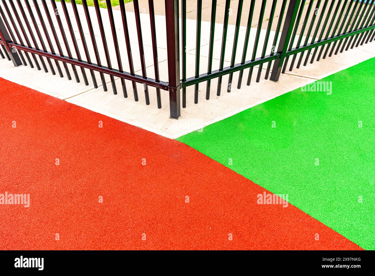 Close-up photo of an ornamental black metal fence surrounding a multi ...