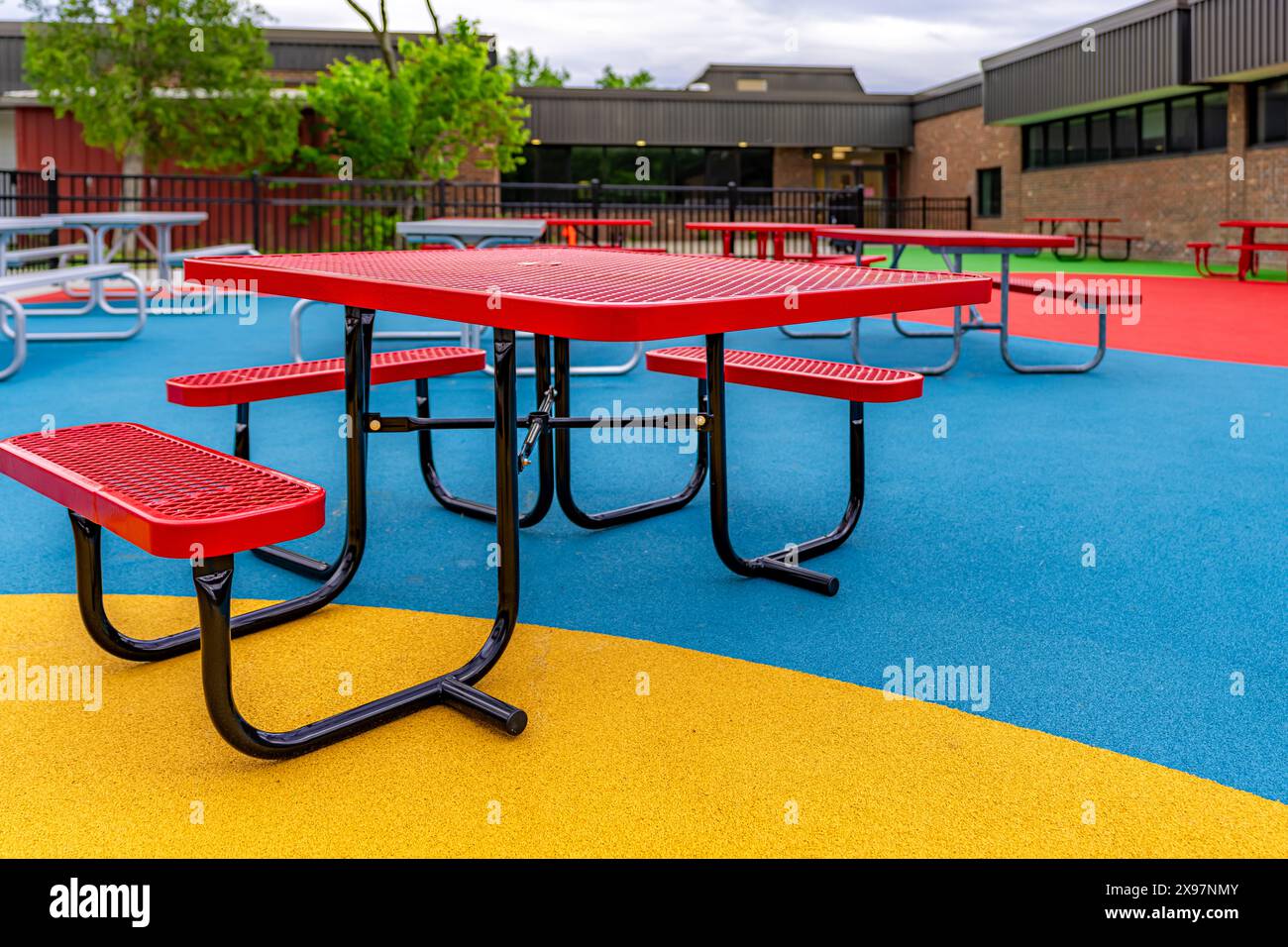 Red vinyl coated ADA, wheelchair, accessible picnic table on a multi ...