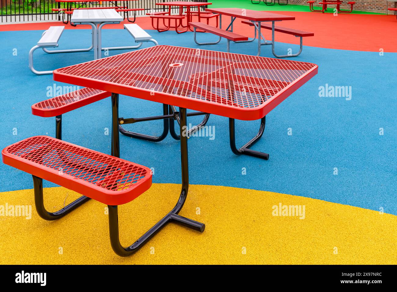 Red vinyl coated ADA, wheelchair, accessible picnic table on a multi ...