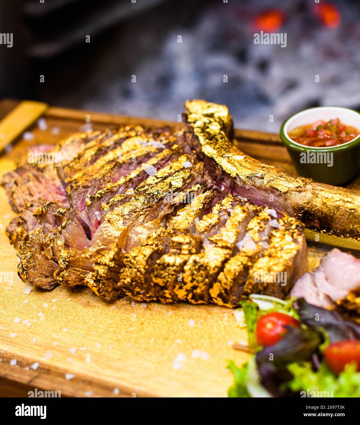 Premium beef tomahawk coated in edible gold Stock Photo - Alamy