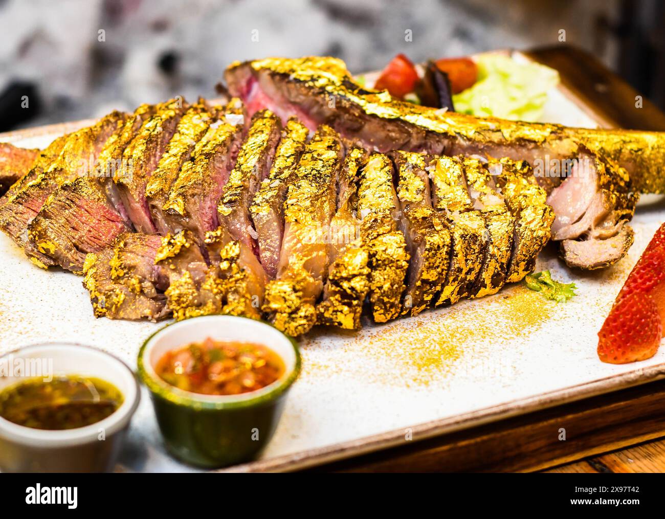 Premium beef tomahawk coated in edible gold Stock Photo - Alamy