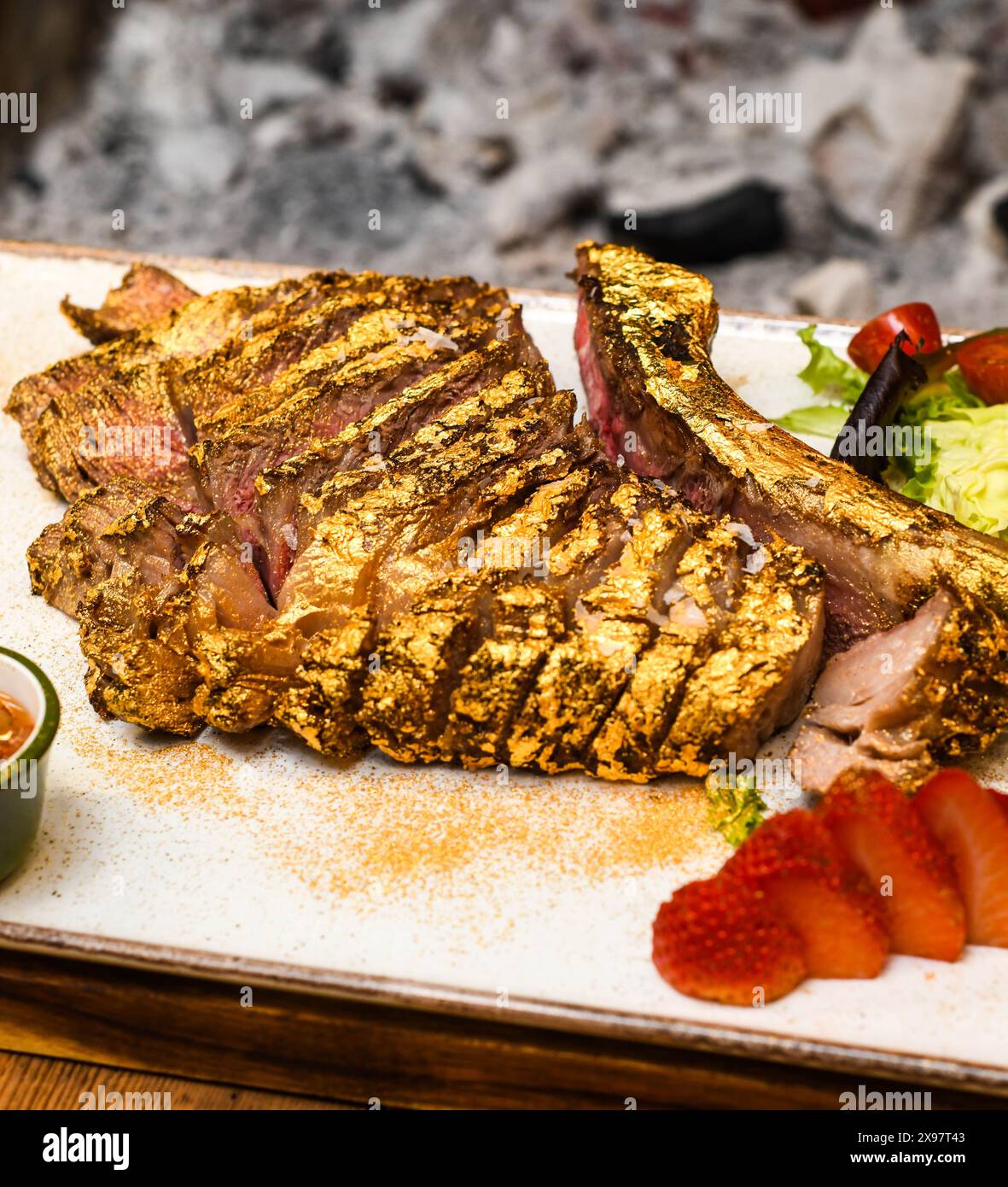 Premium beef tomahawk coated in edible gold Stock Photo - Alamy