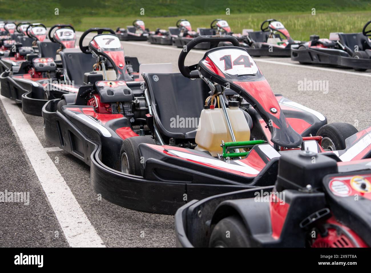 Red black go-karts on the side of a track Stock Photo - Alamy