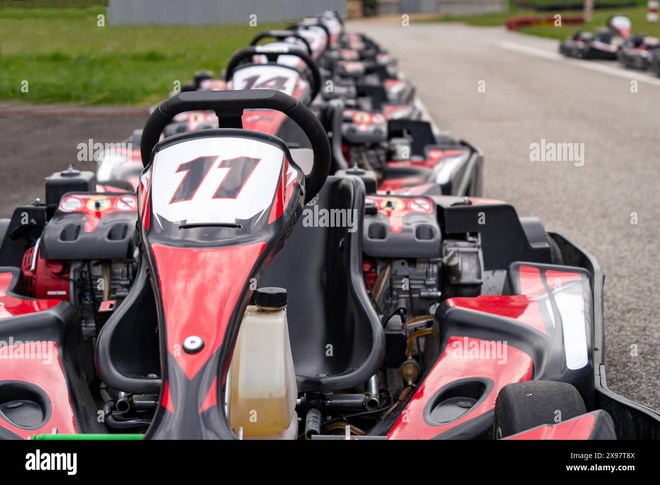 Red black go-karts on the side of a track Stock Photo - Alamy