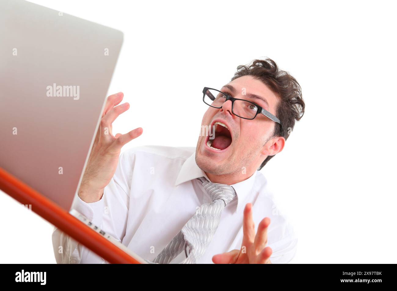 stressed out man with glasses on white background looking at laptop ...