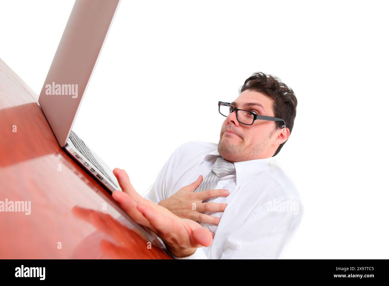 stressed out man with glasses on white background looking at laptop ...