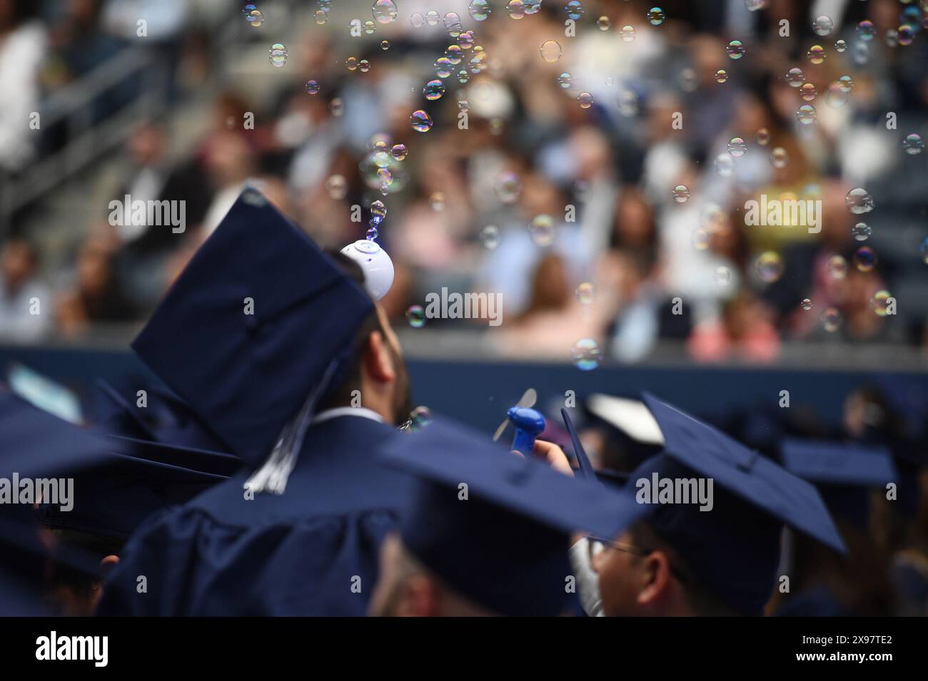 Members of the 2024 graduating class celebrate during Yeshiva ...