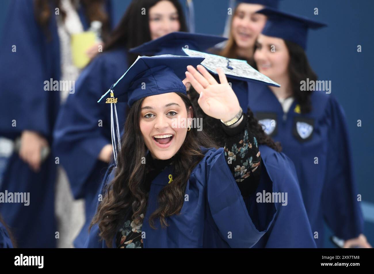 Members of the 2024 graduating class arrive to take their seats for ...