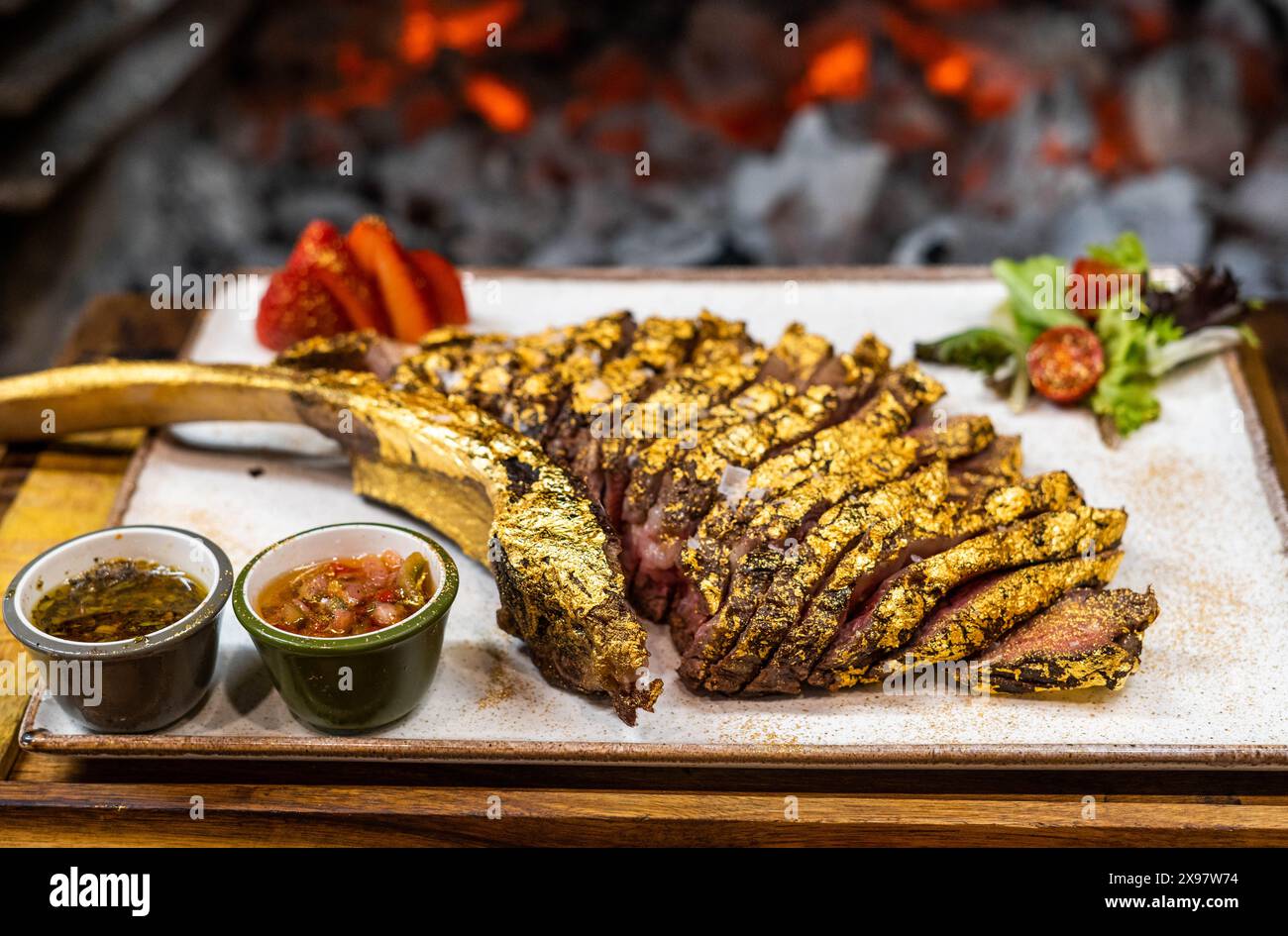 Premium beef tomahawk coated in edible gold Stock Photo - Alamy