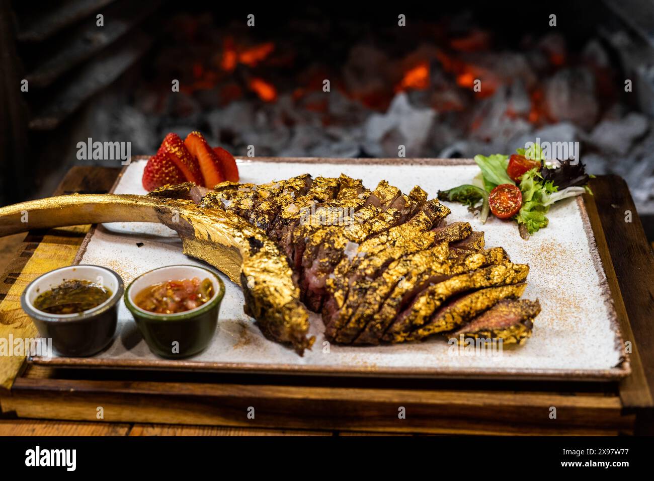 Premium beef tomahawk coated in edible gold Stock Photo - Alamy