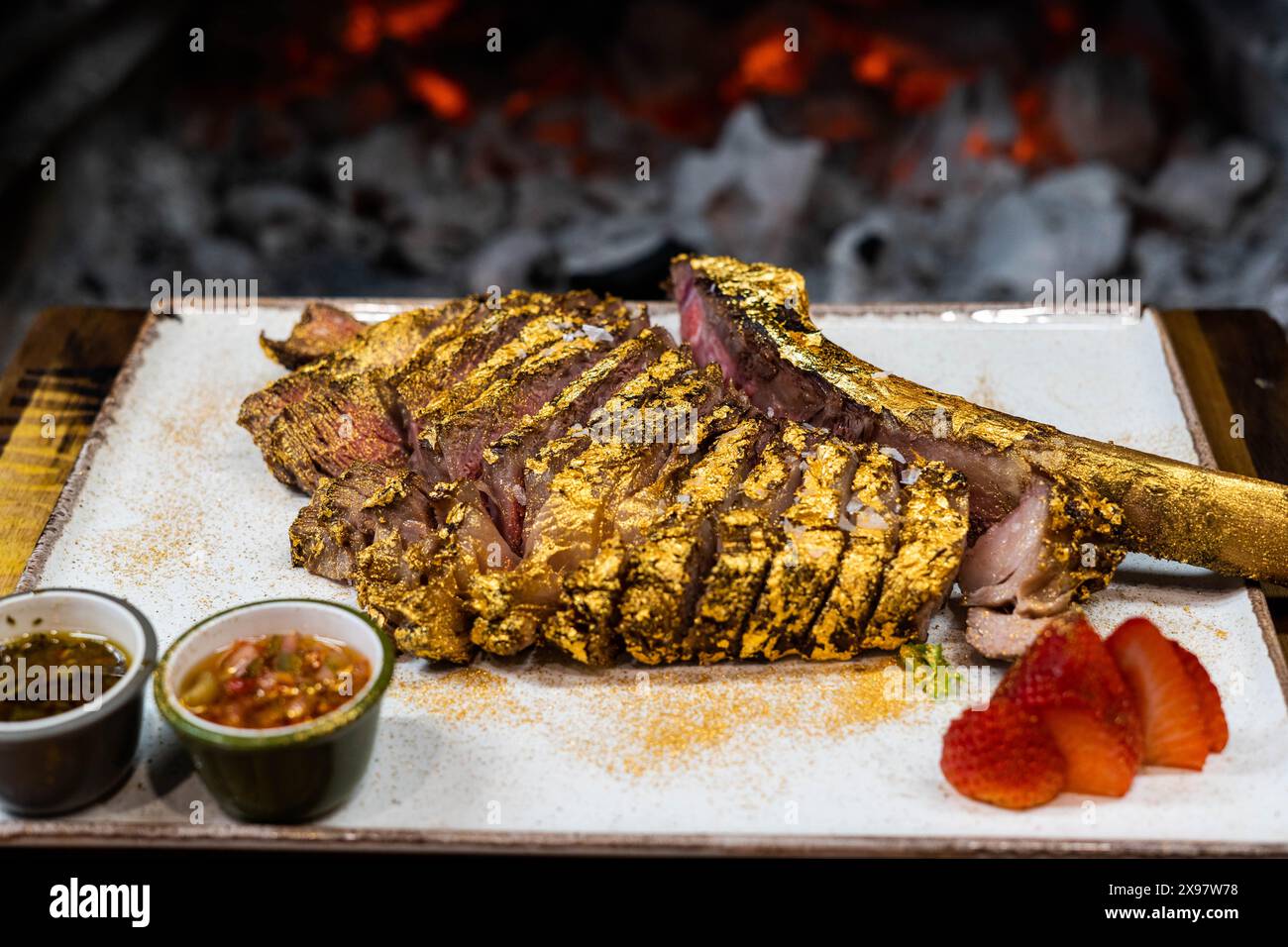 Premium beef tomahawk coated in edible gold Stock Photo - Alamy
