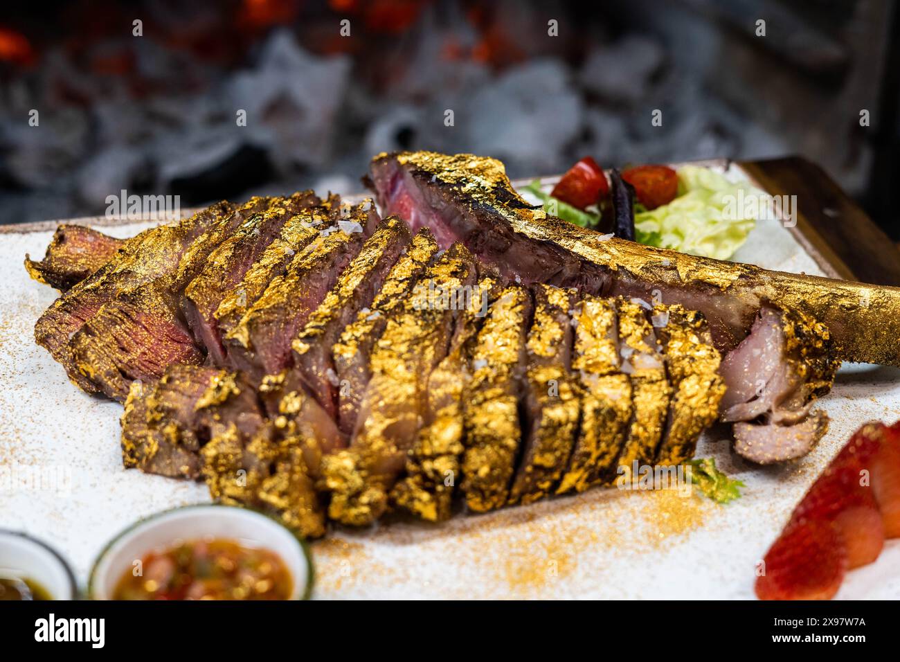 Premium beef tomahawk coated in edible gold Stock Photo - Alamy