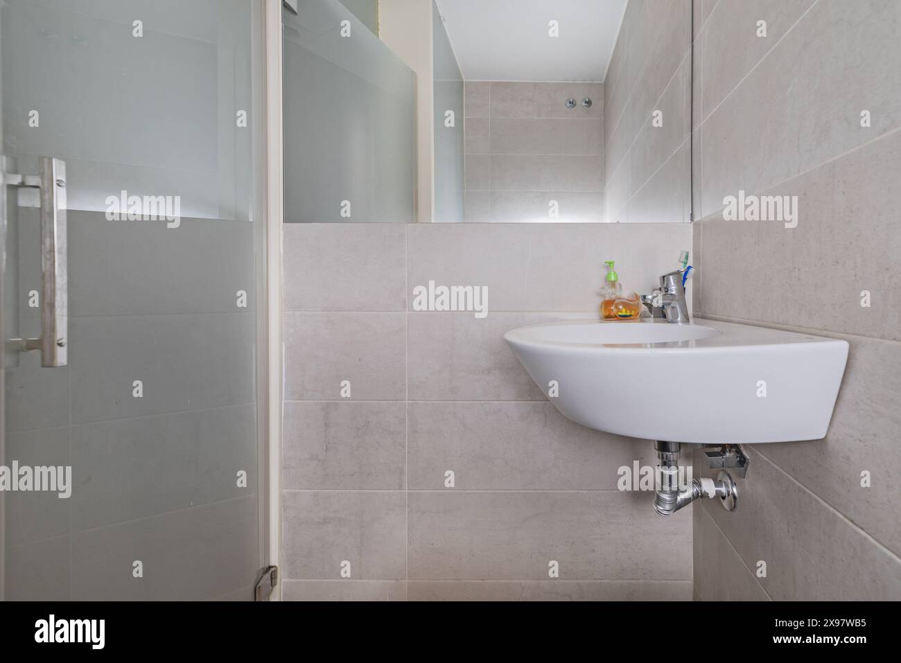 Bathroom with translucent glass door, white porcelain toilets and ...