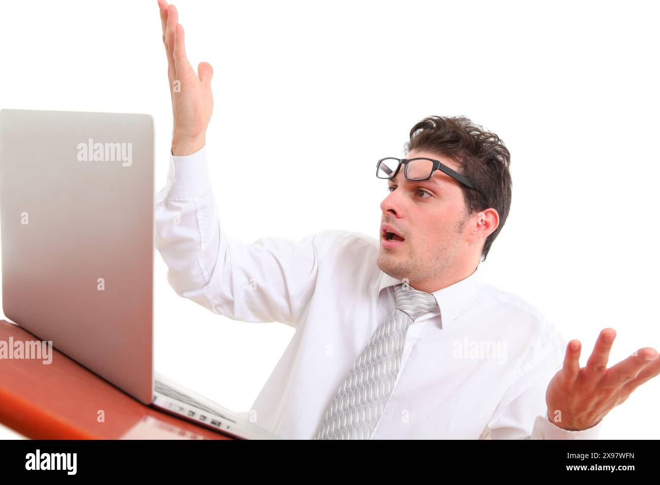 stressed out man with glasses on white background looking at laptop ...